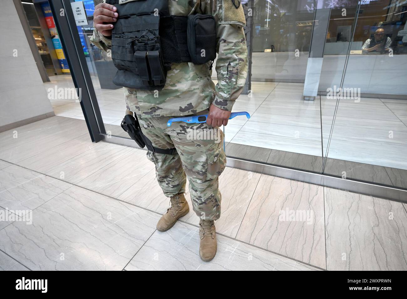 New York, USA. 01st Apr, 2024. A National Guardsman holds a free pair ...