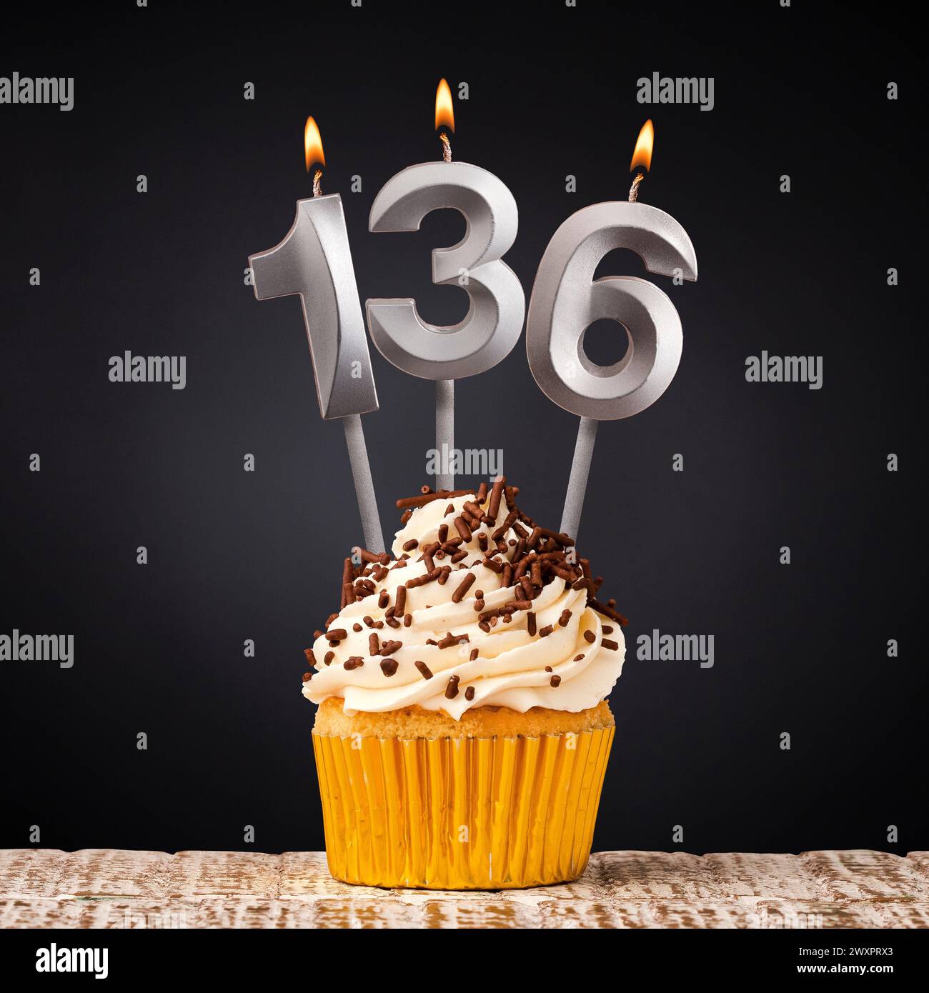 birthday cupcake with number 136 candle - Celebration on dark ...