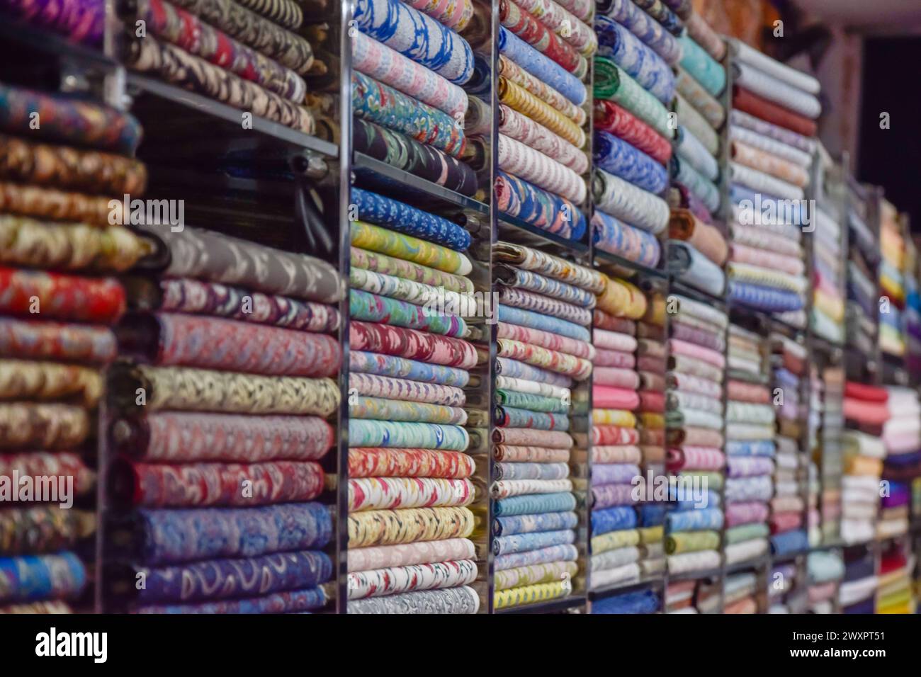 Indian textiles for saris with variety of colors shown in shop at local ...