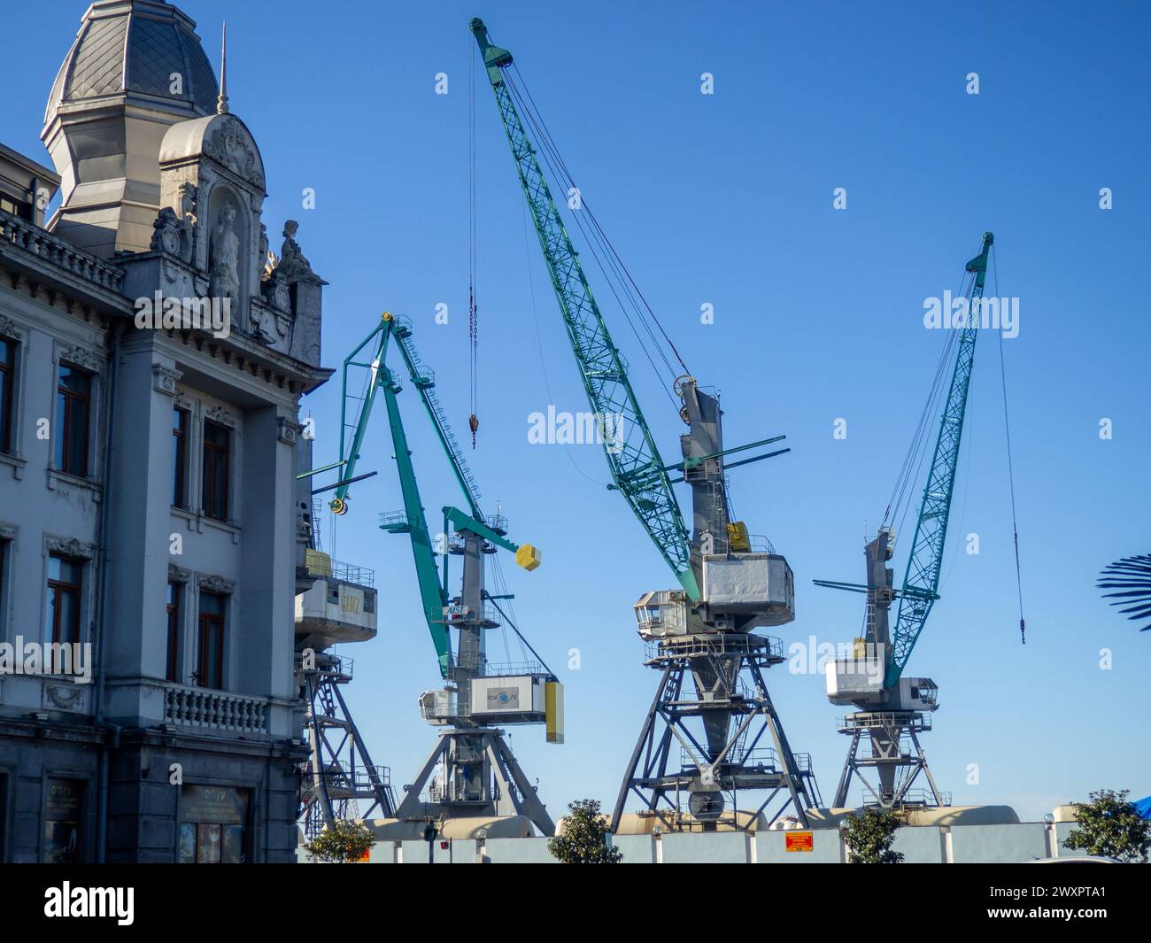 Marine cranes. Loading heavy loads. Cranes against the sky Stock Photo ...