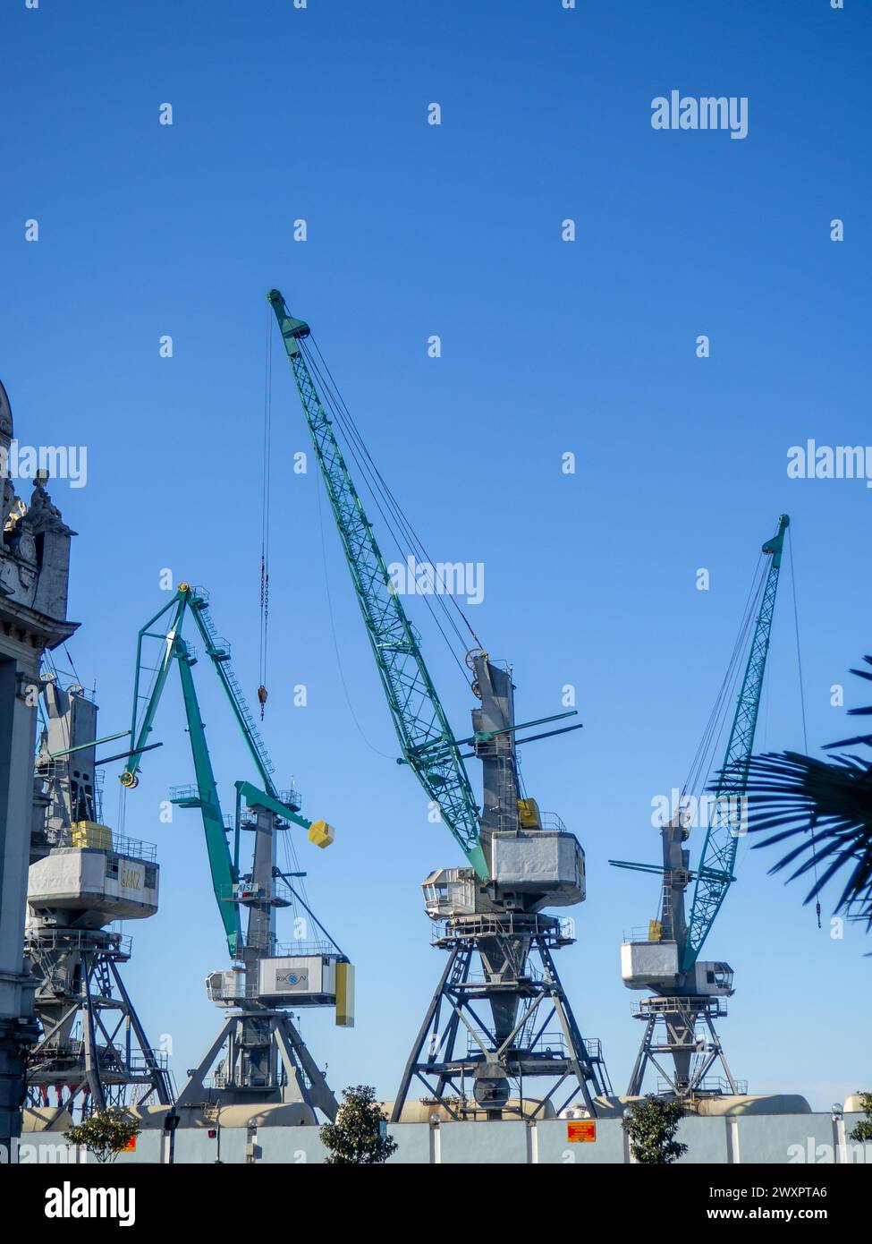 Marine cranes. Loading heavy loads. Cranes against the sky Stock Photo ...