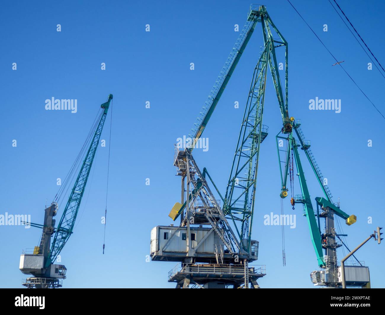 Marine cranes. Loading heavy loads. Cranes against the sky Stock Photo ...
