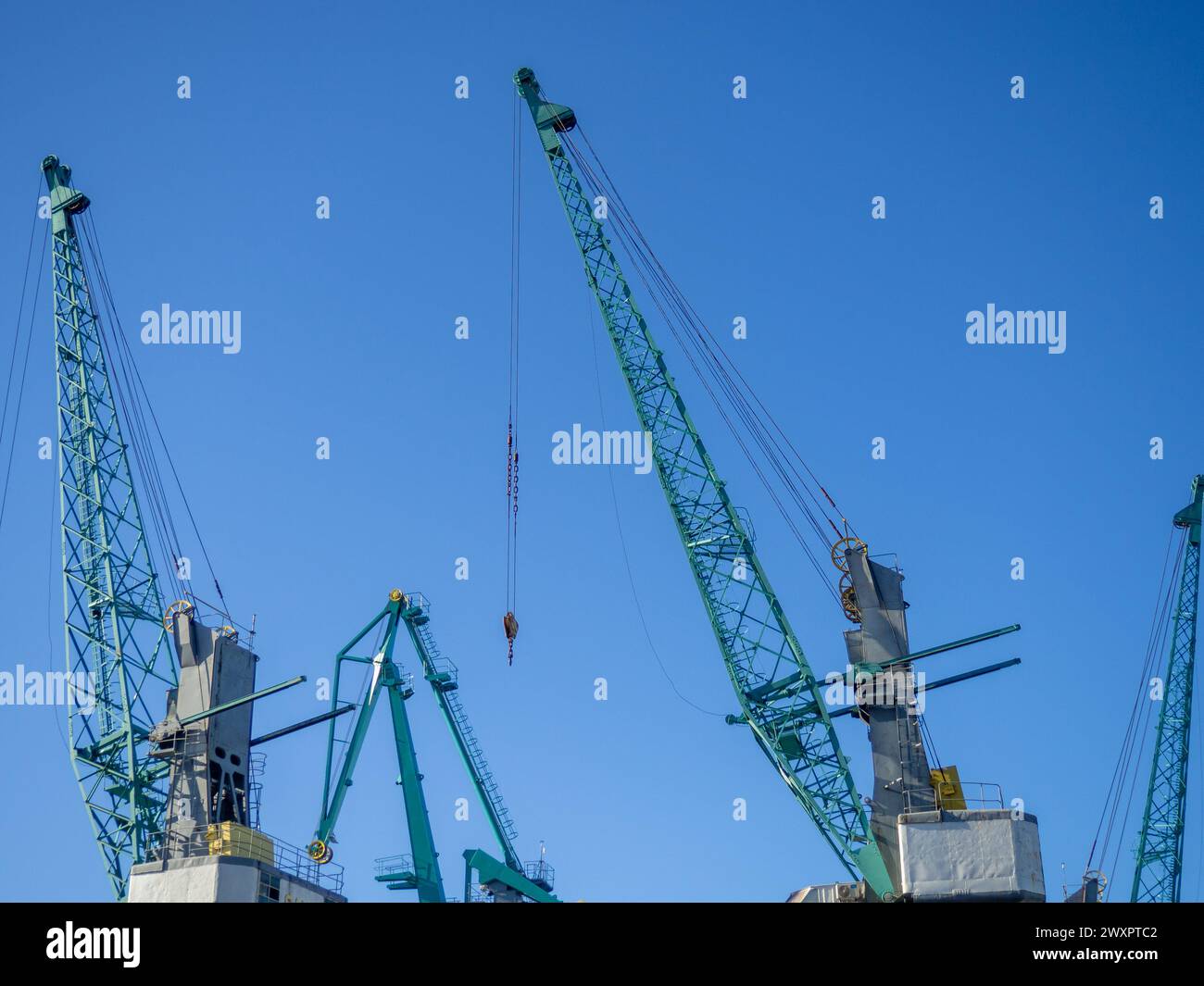 Marine cranes. Loading heavy loads. Cranes against the sky. Port ...