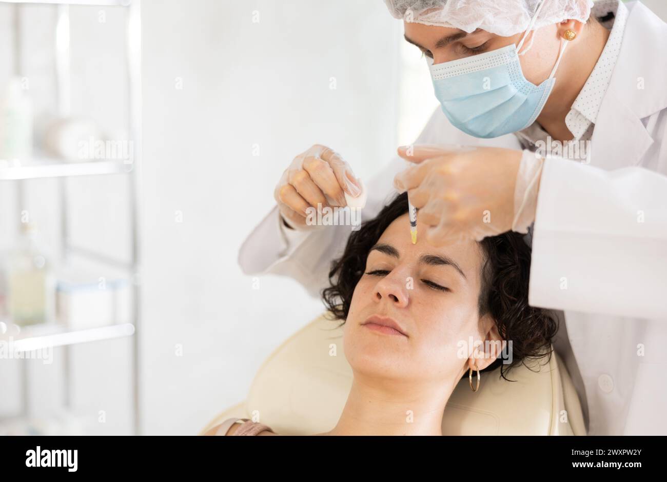 Doctor giving face lifting injection hi-res stock photography and ...