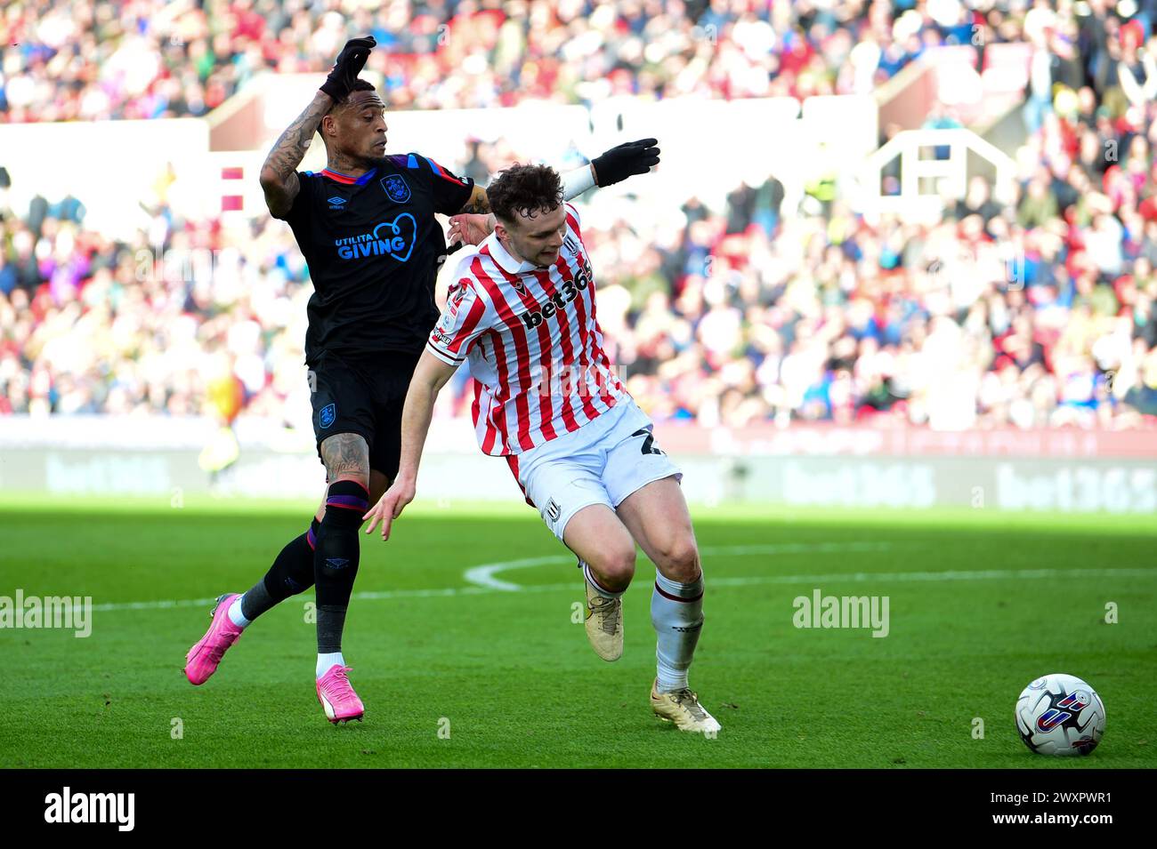 Luke McNally of Stoke City denies Delano Burgzorg of Huddersfield Town ...