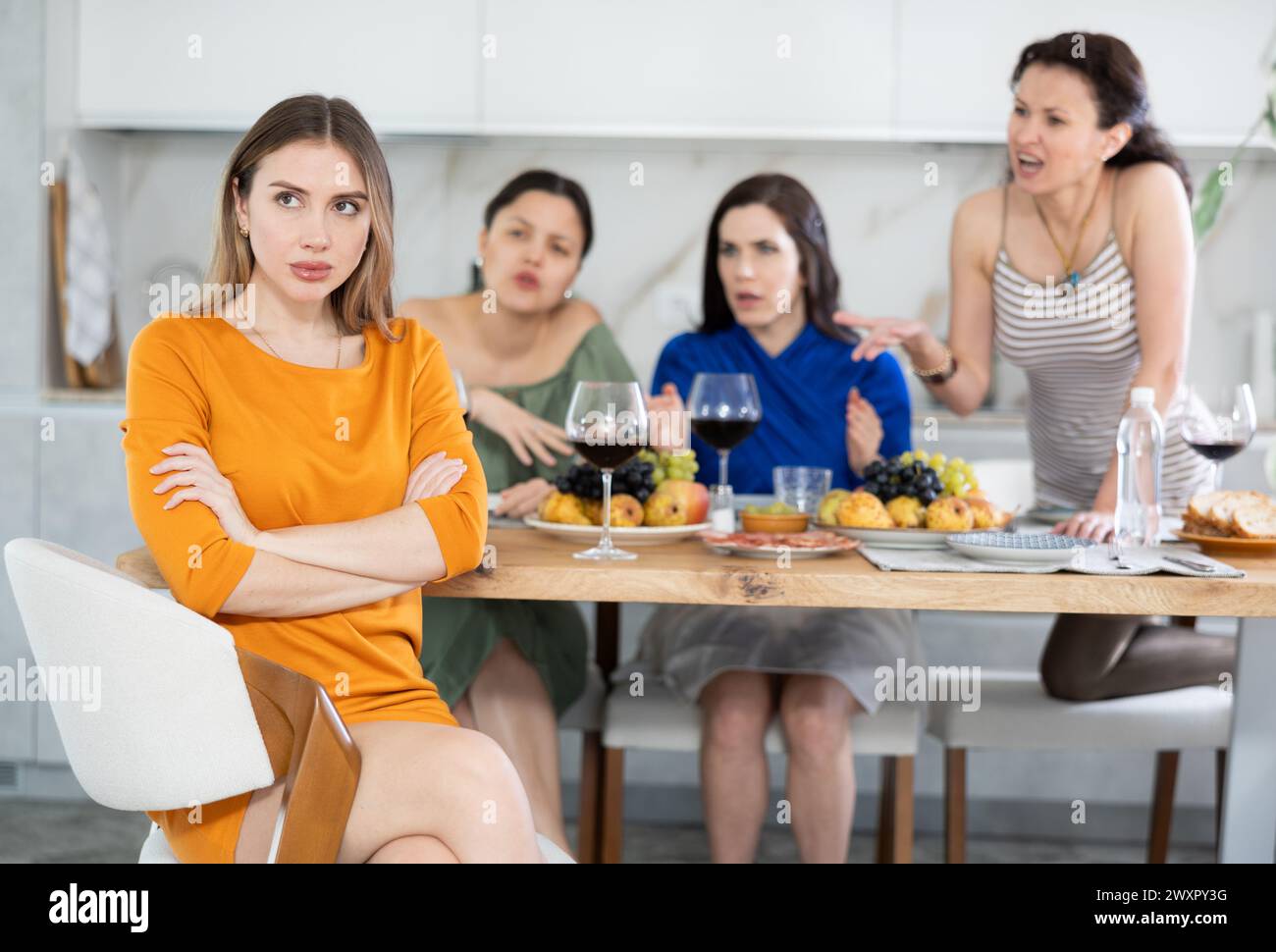 Group of girlfriends at party scold their friend. Quarrel at ...