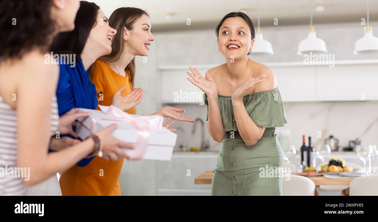 Happy women greeting each other before starting house party Stock Photo ...