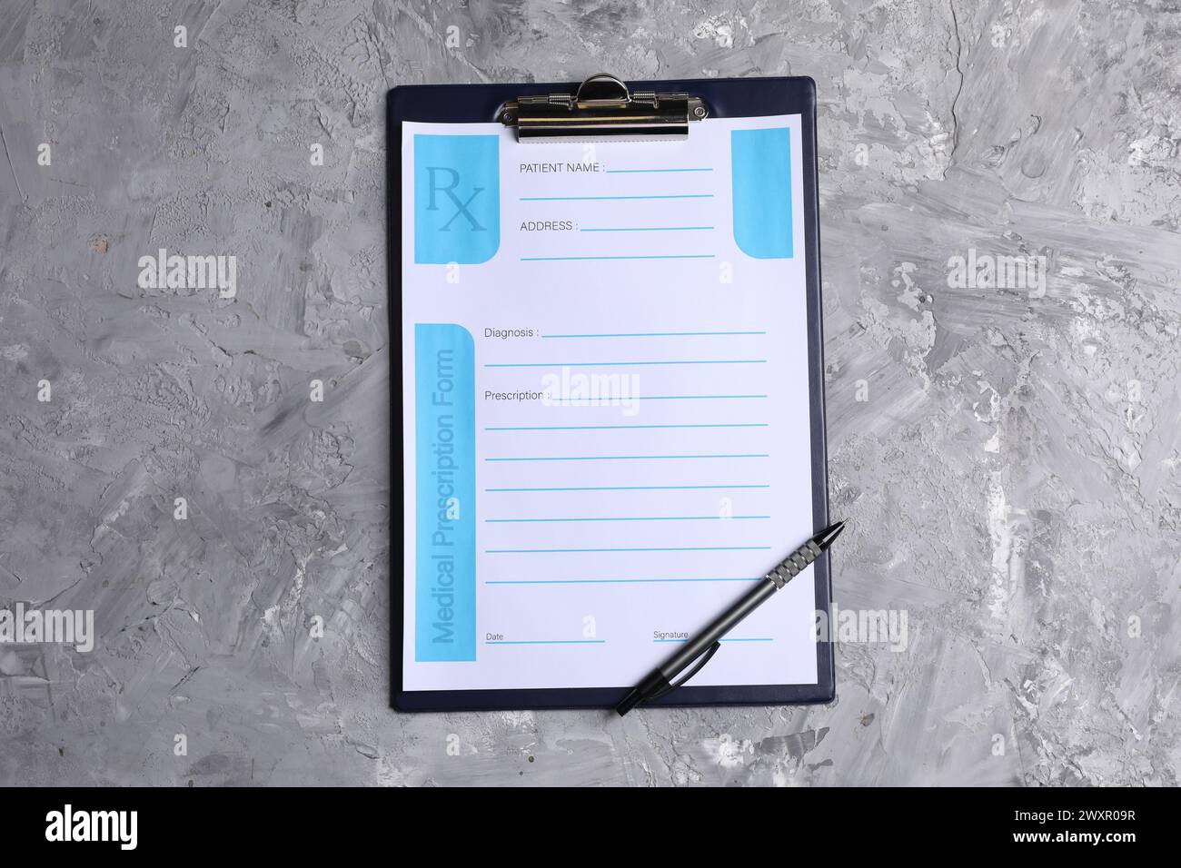 Medical prescription form with empty fields and pen on grey textured ...