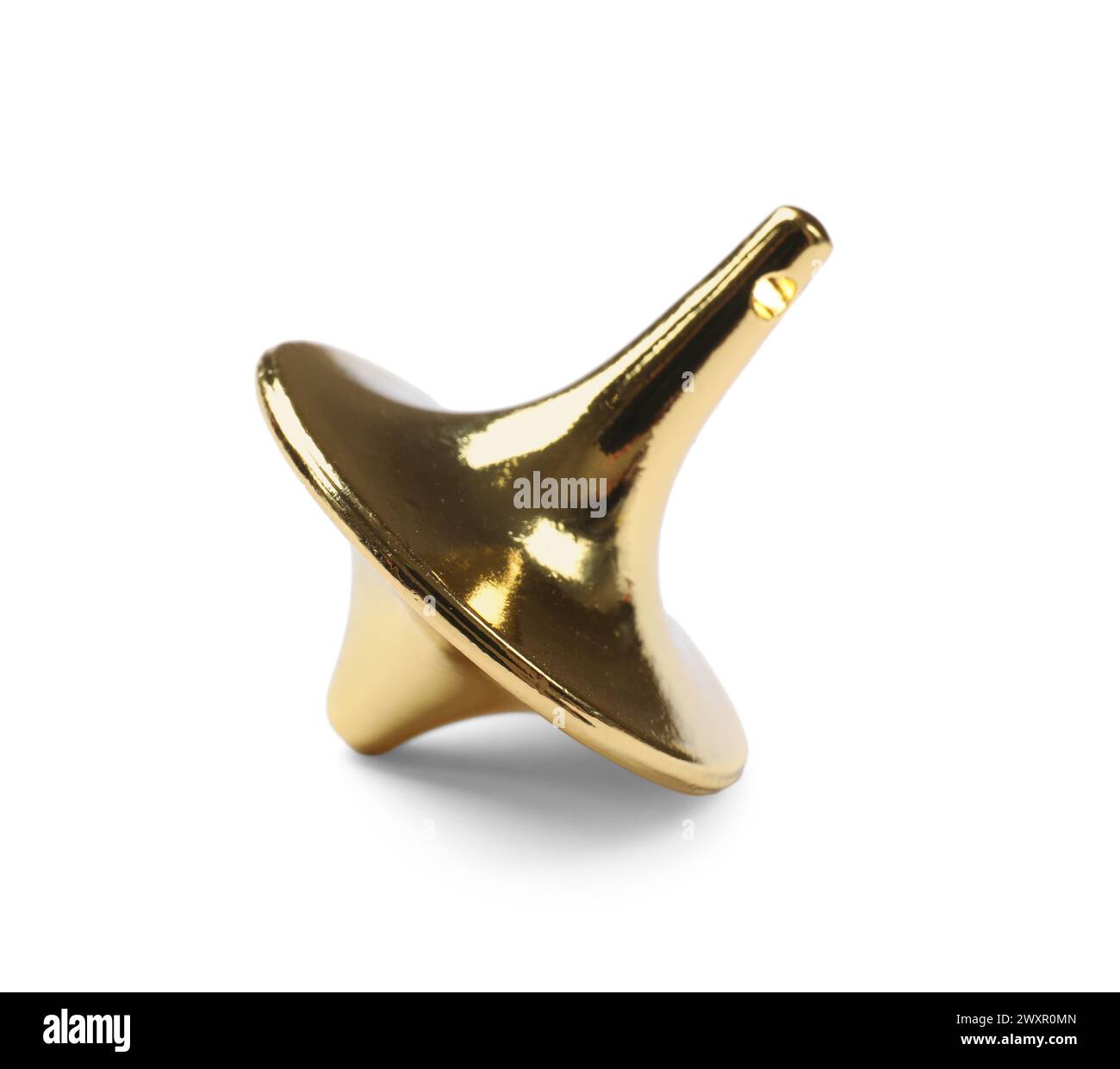 One golden spinning top on white background Stock Photo - Alamy