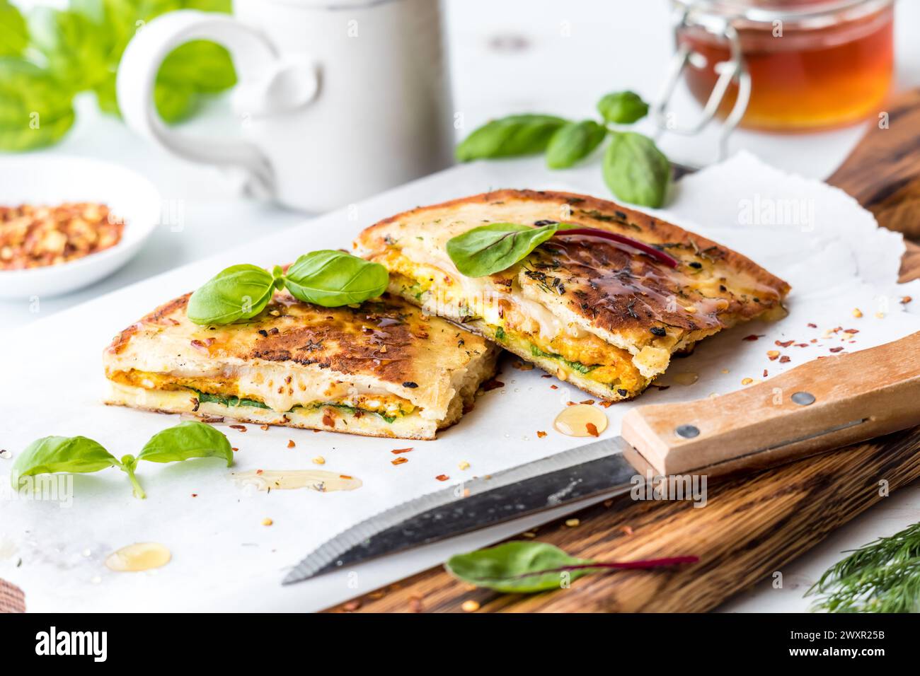 Egg and cheese naan bread breakfast sandwiches topped with honey and ...