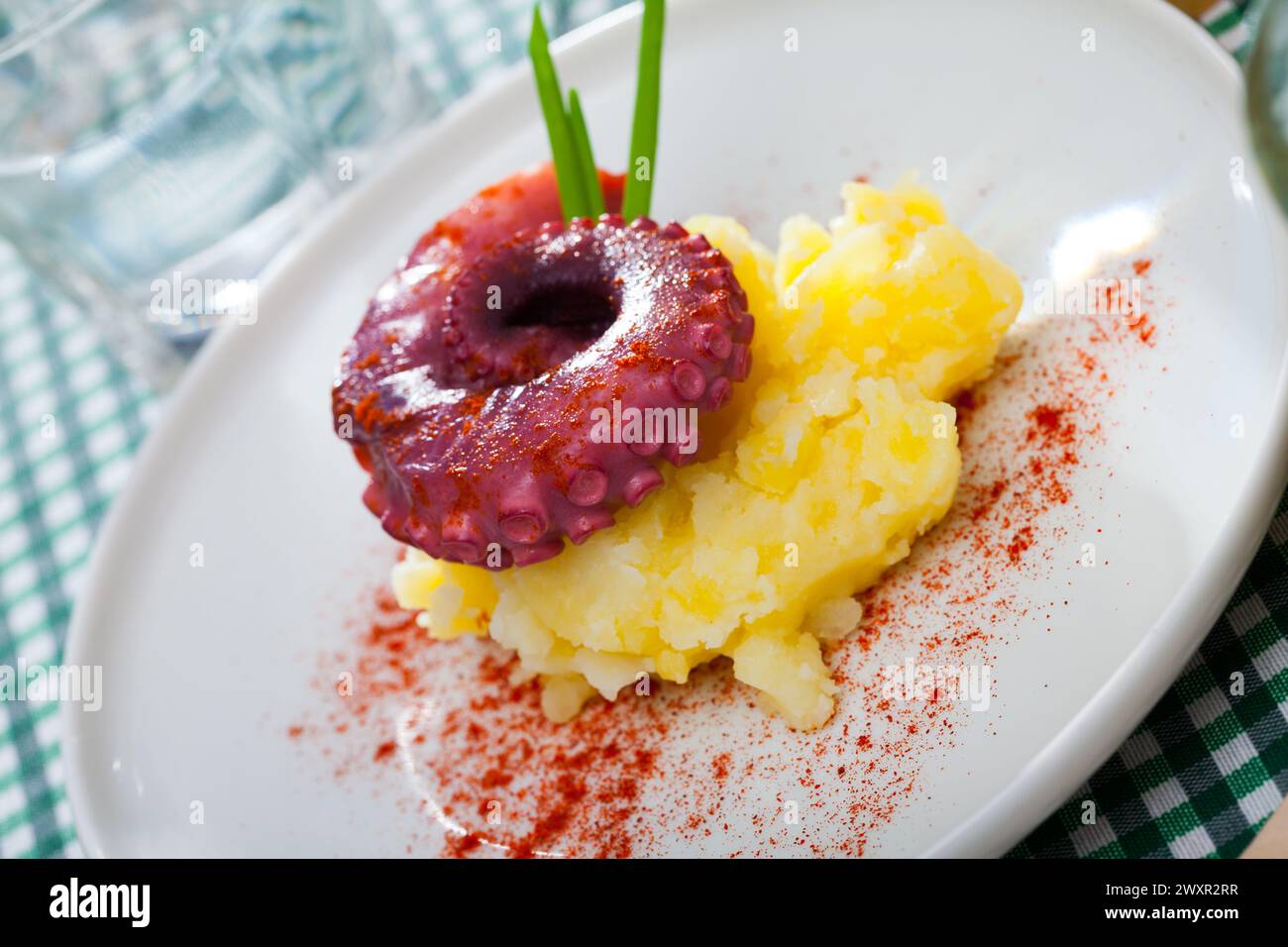 Seafood dish - boiled octopus with potato Stock Photo - Alamy