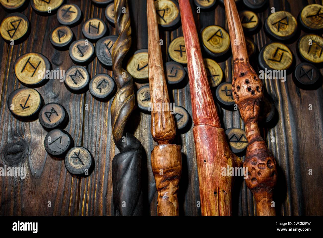 Homemade magic wands and wooden runes on a dark wooden background Stock ...