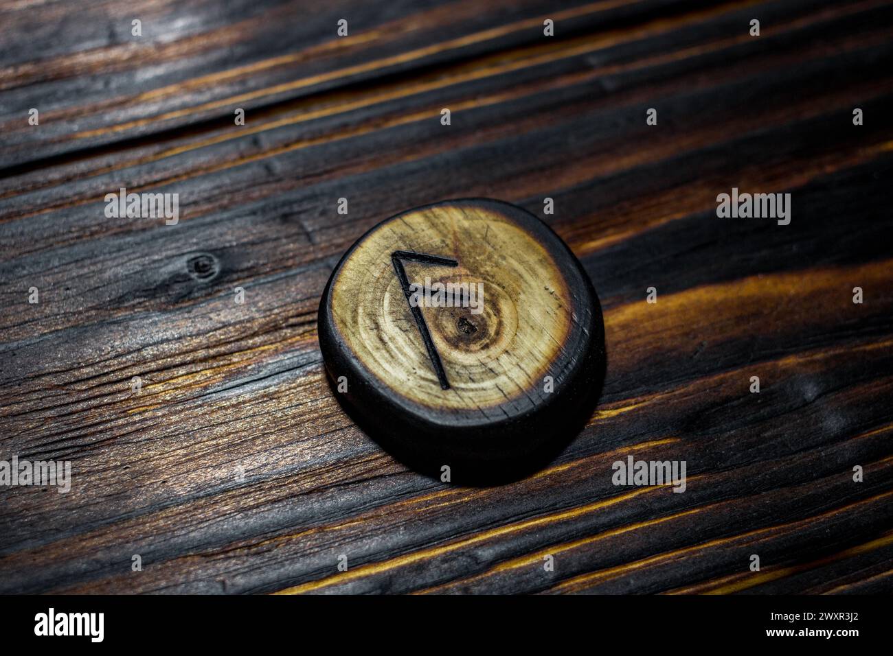 Rune Ansuz carved from wood on a wooden background - Elder Futhark ...
