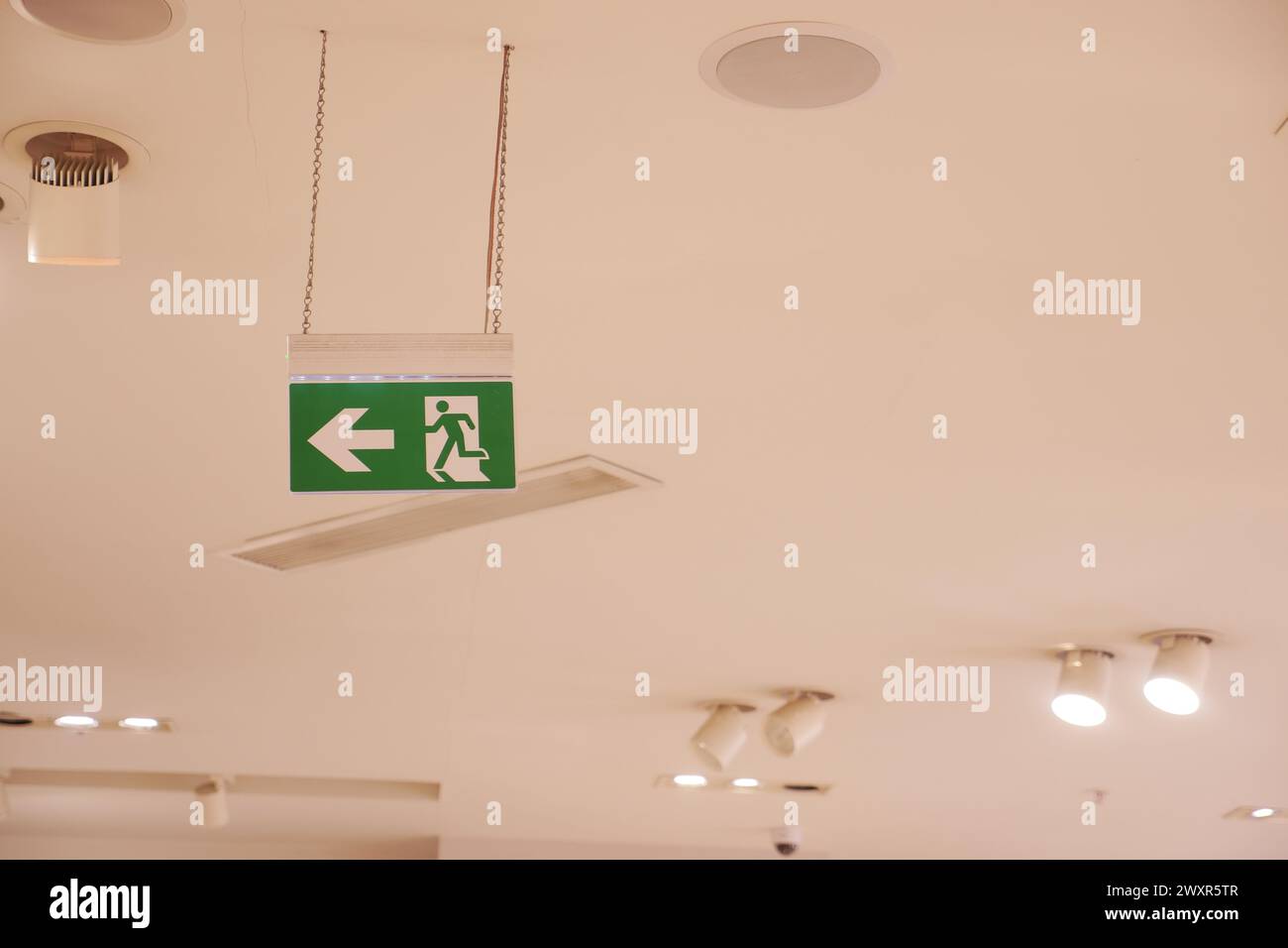 Fire exit sign at the corridor in building Stock Photo - Alamy