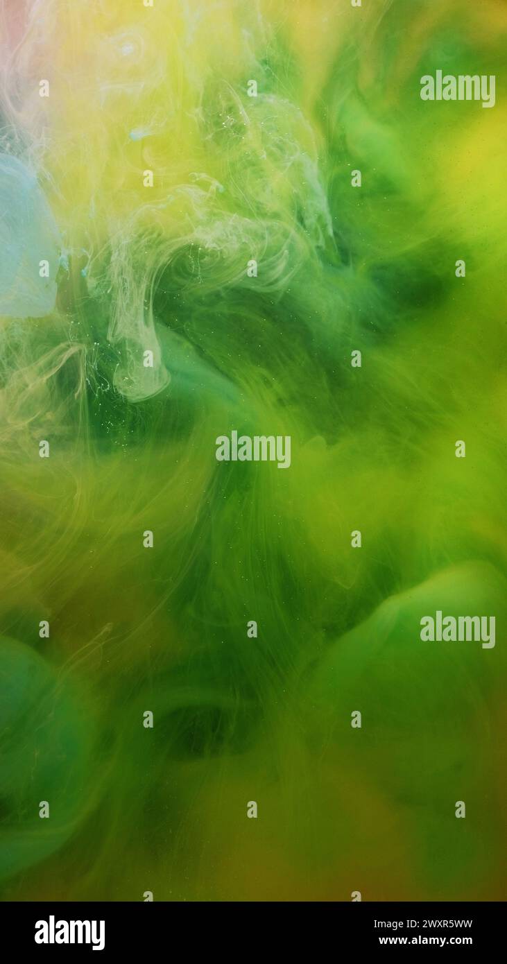 Magic haze. Paint water mix. Green yellow orange color vapor cloud ...