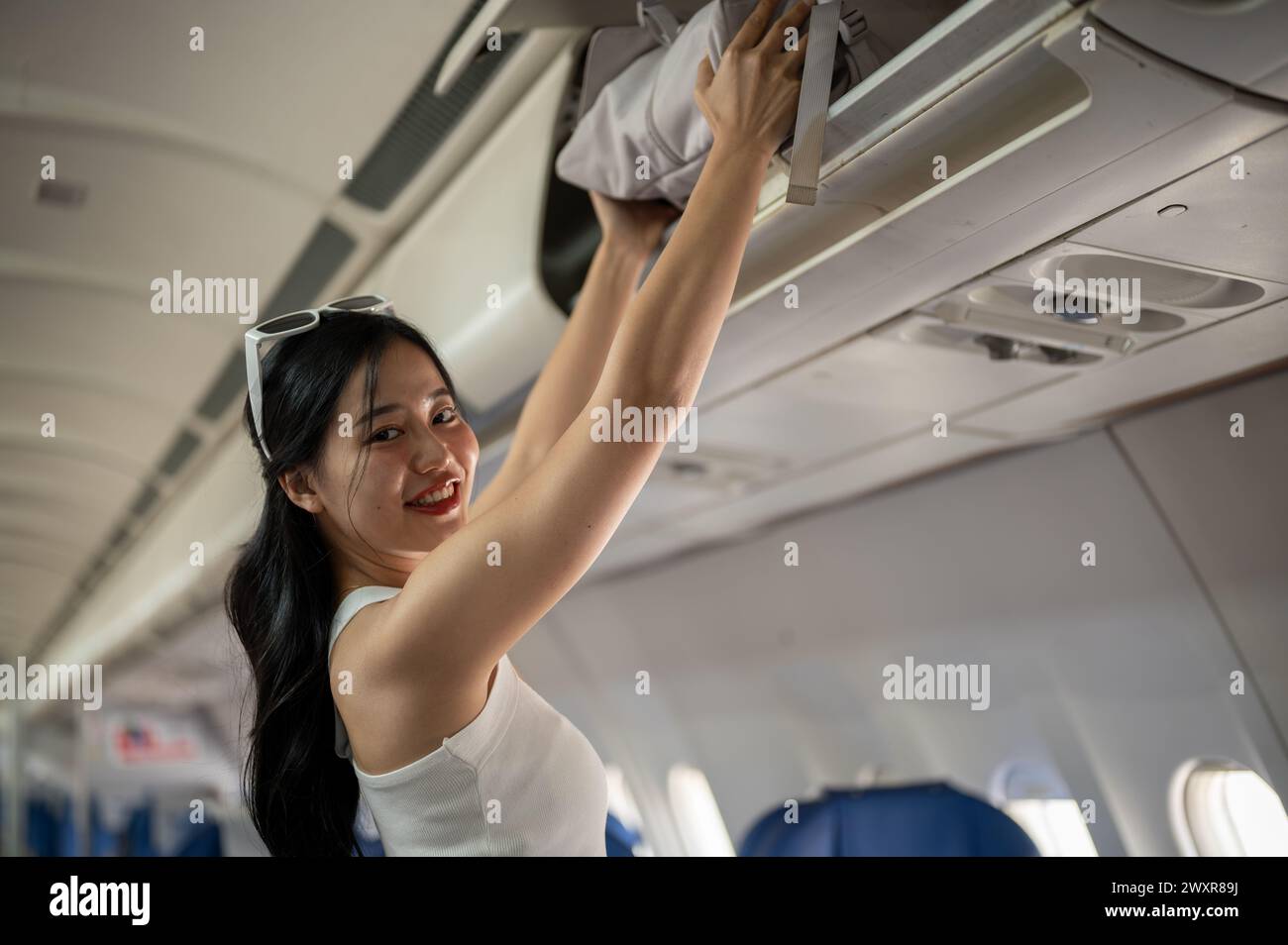 Overhead locker plane hi-res stock photography and images - Alamy
