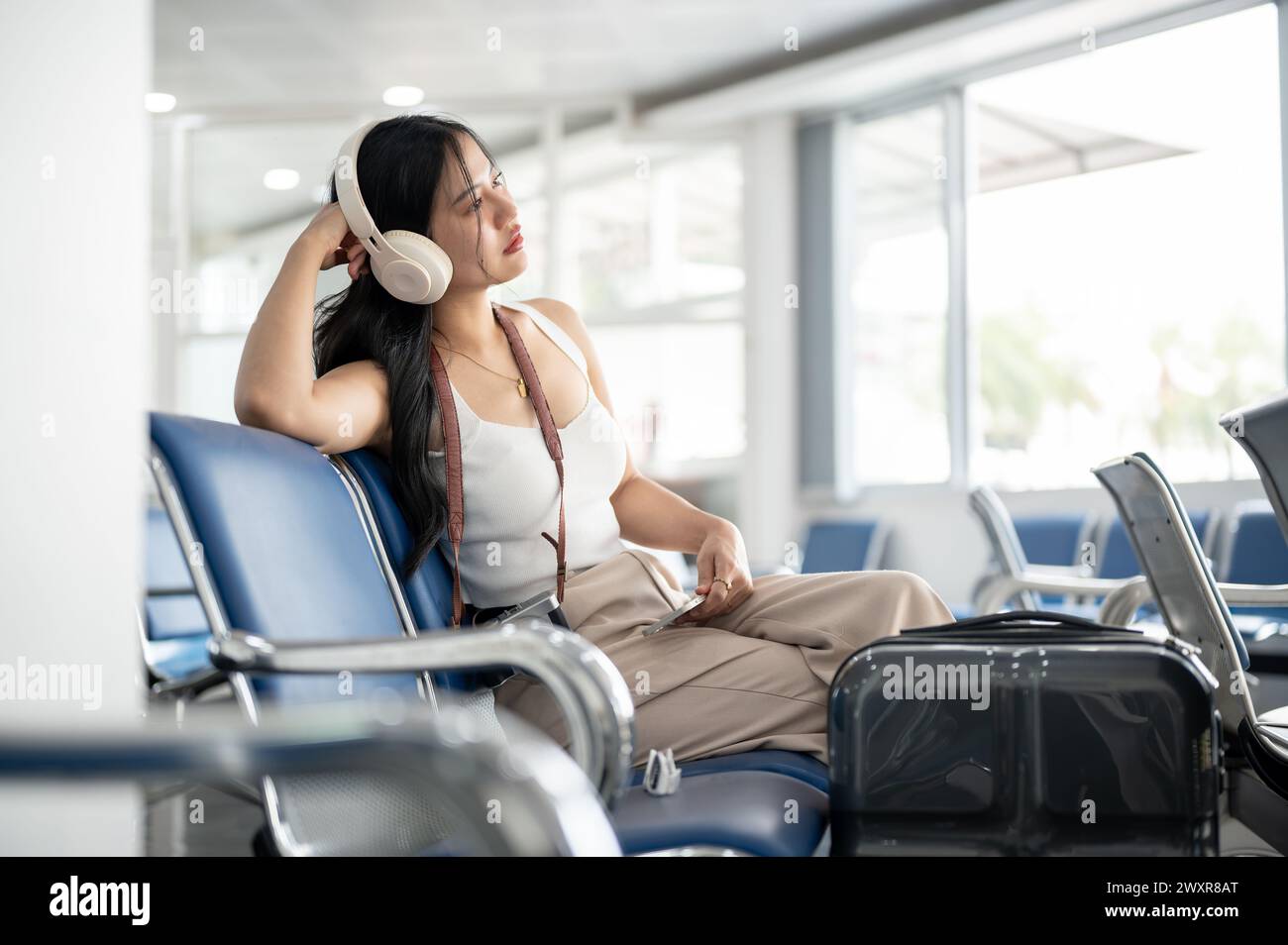 Tired woman sitting airport boarding hi-res stock photography and images - Alamy