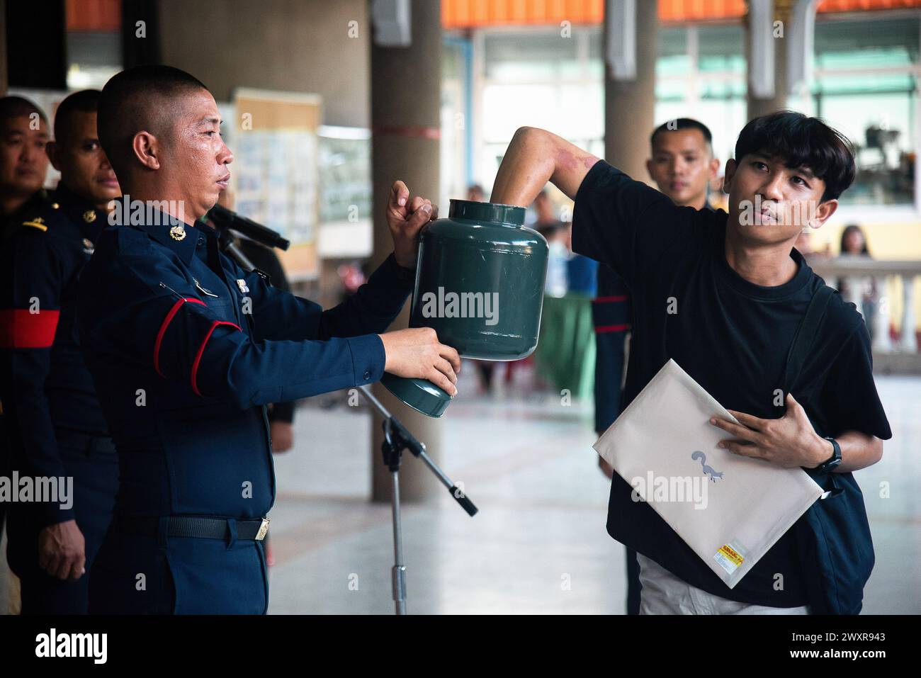 Bangkok, Thailand. 01st Apr, 2024. A Thai man draws a lottery during an ...