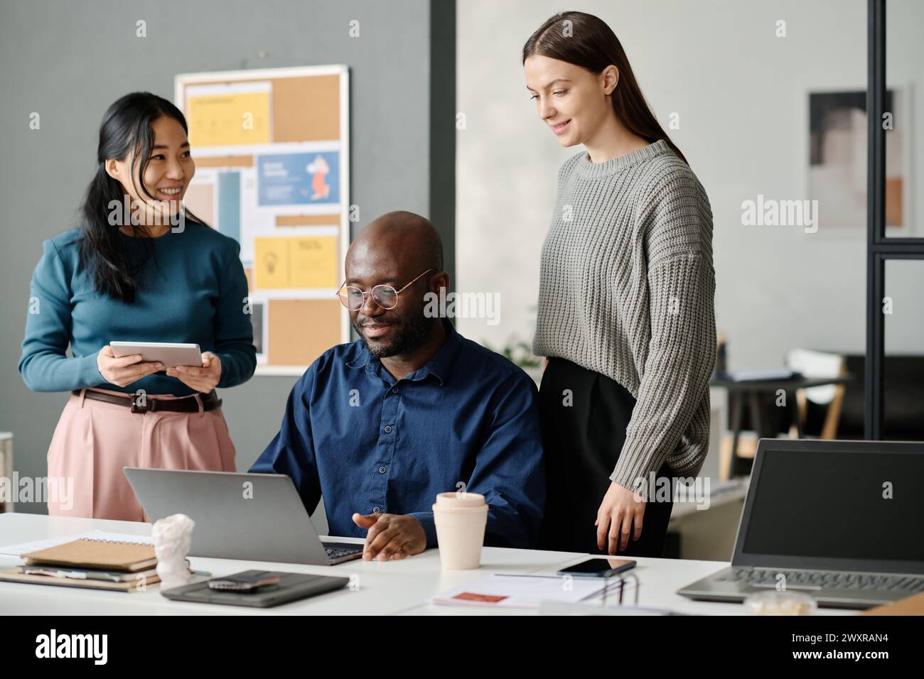 Group of three ethnically diverse man and women working together on ...