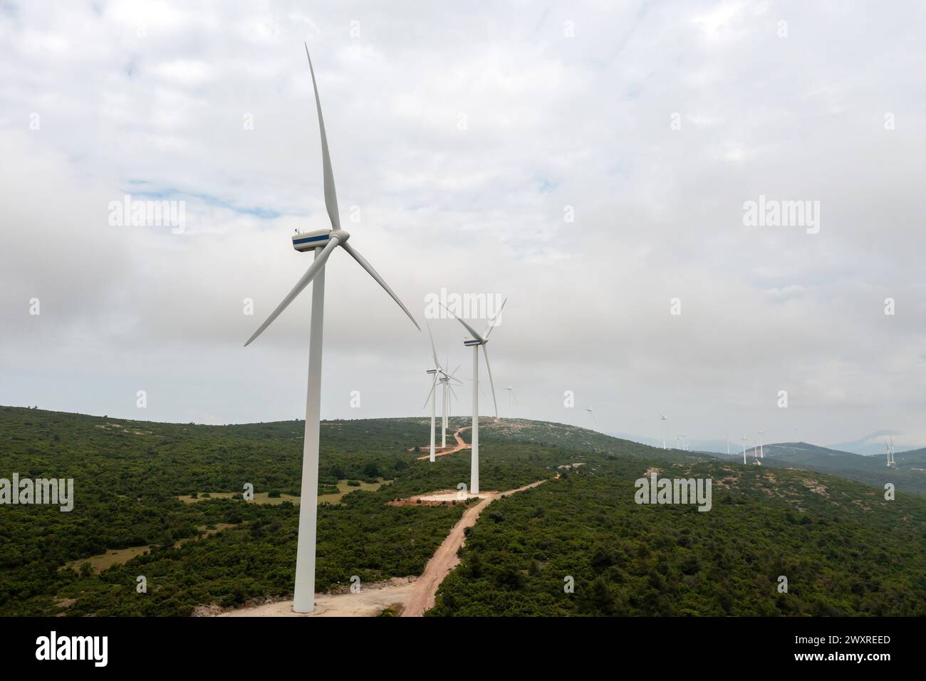 Wind Generator, Wind turbine at curvy road on hill. Greek alternative ...