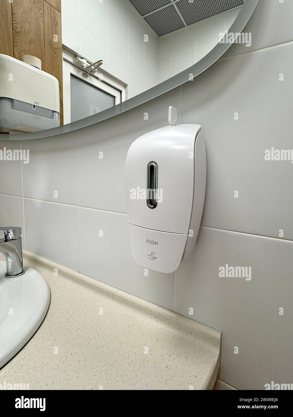 soap dispenser in small public toilet Stock Photo - Alamy