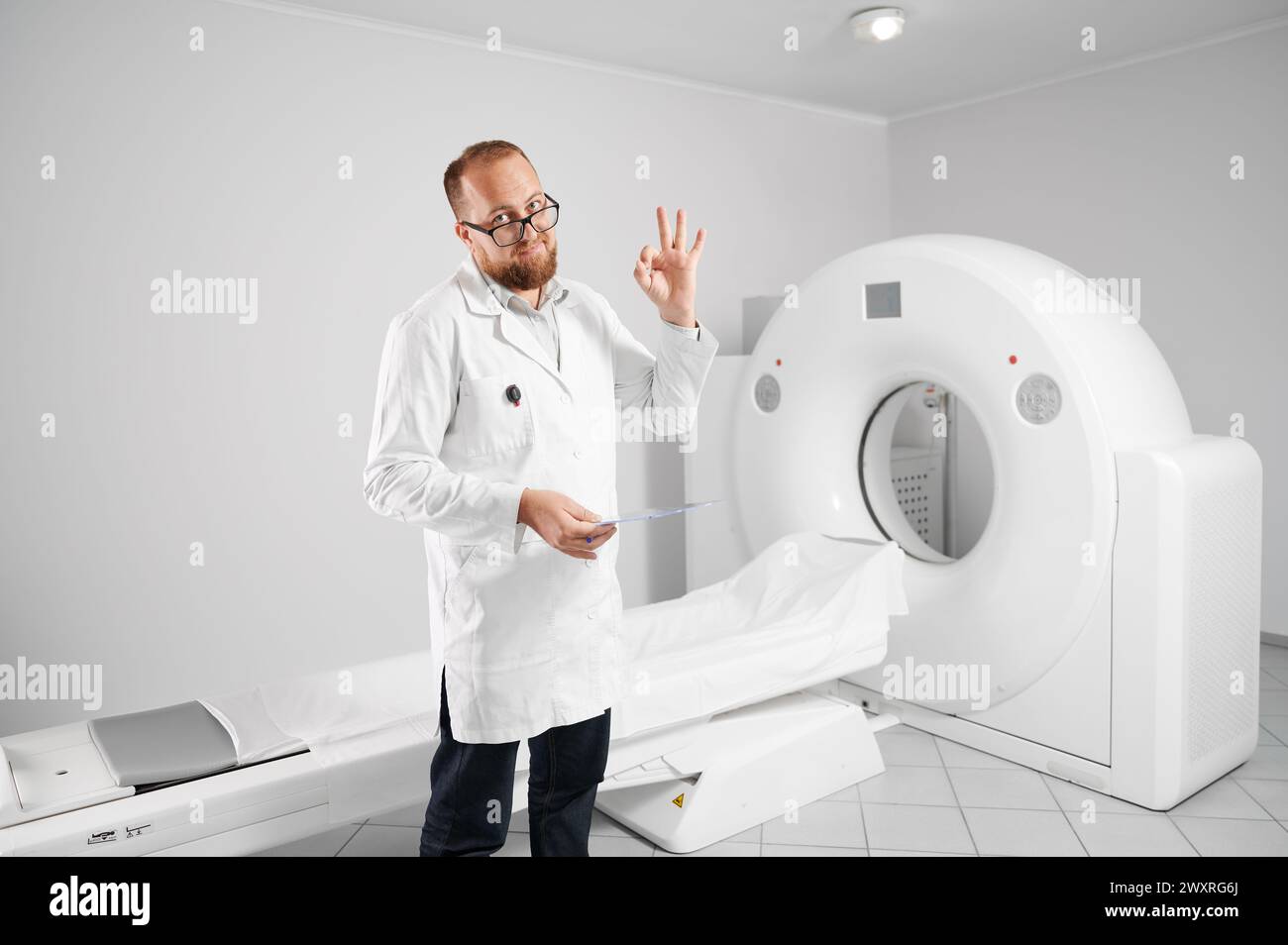 Portrait of doctor with medical computed tomography or MRI scanner ...