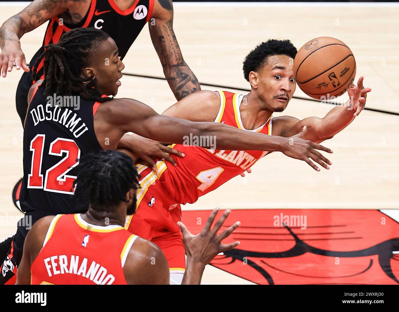 Chicago, USA. 1st Apr, 2024. Atlanta Hawks guard Kobe Bufkin (R) passes ...