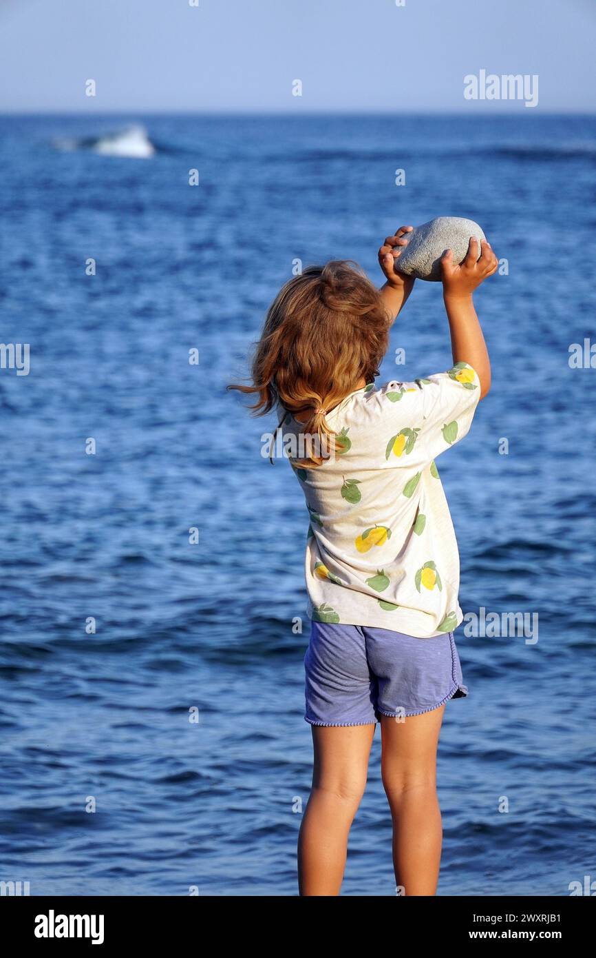 Child throws stone hi-res stock photography and images - Alamy