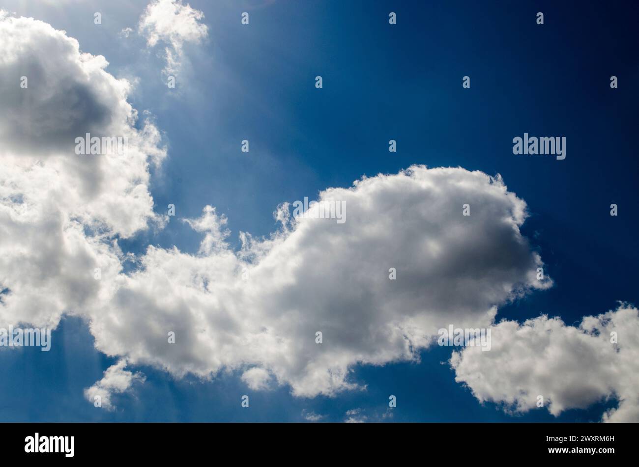 Blue sky with white clouds in sun rays, pure sky background Stock Photo ...