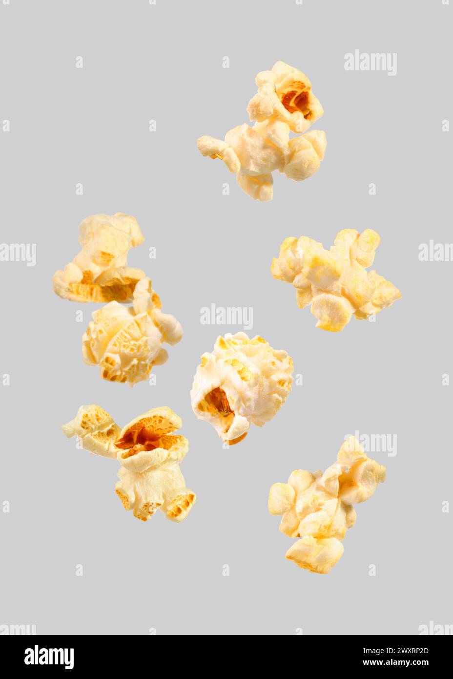Tasty fresh popcorn flying on grey background Stock Photo - Alamy