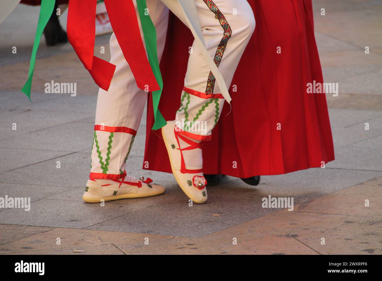 A diverse group of Basque folk dancers during a festival in the street ...
