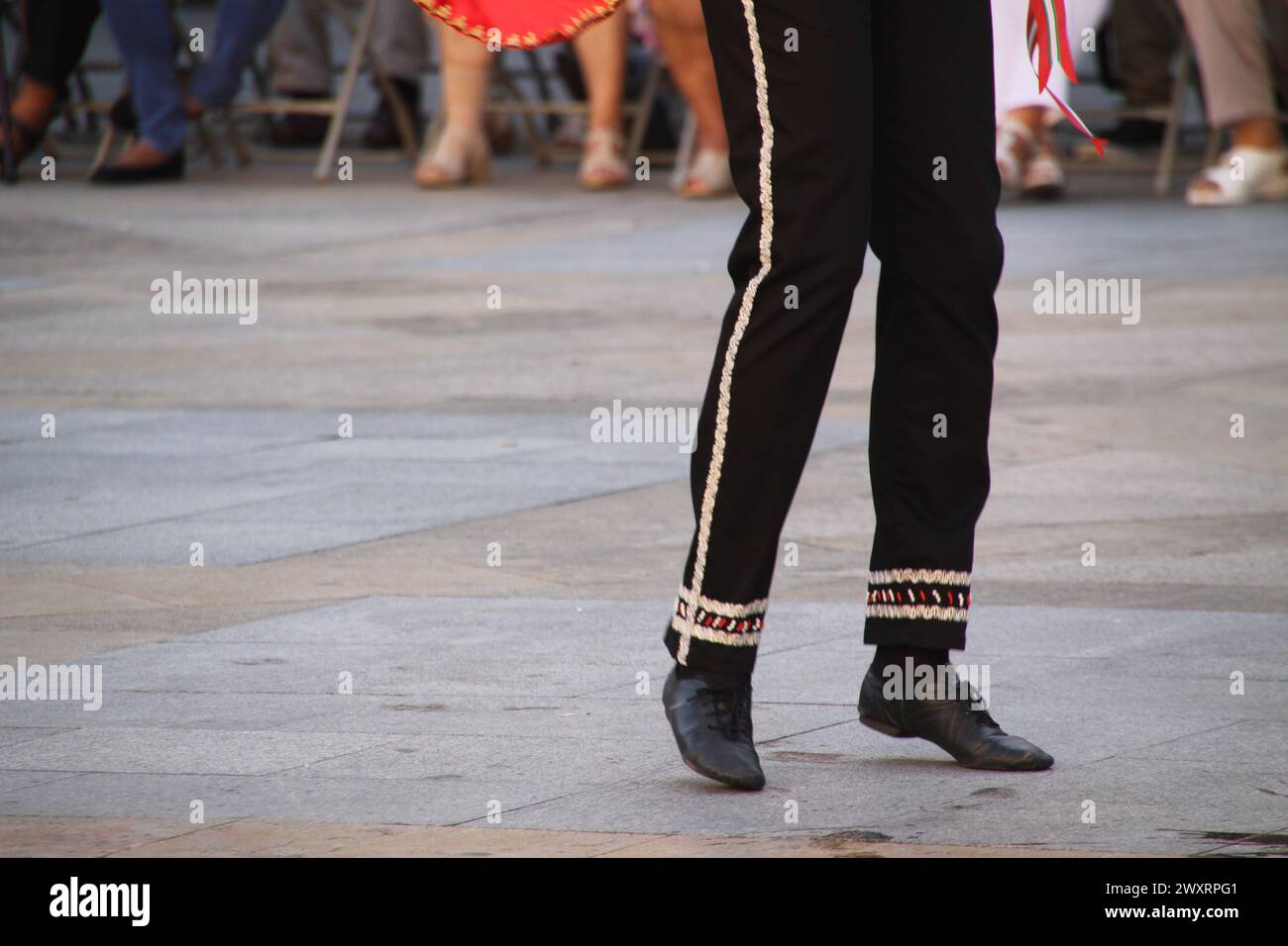 A diverse group of Basque folk dancers during a festival in the street ...