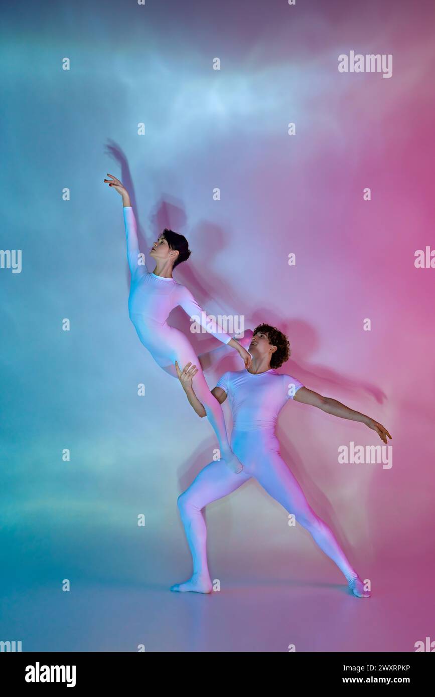 Ballet duo mid-performance, male dancer lifting female dancer against ...