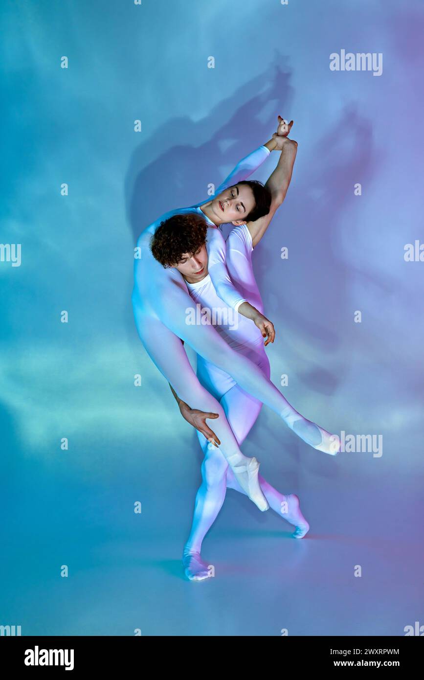 Athletic ballet pair in lift, with male in lunge supporting extended ...
