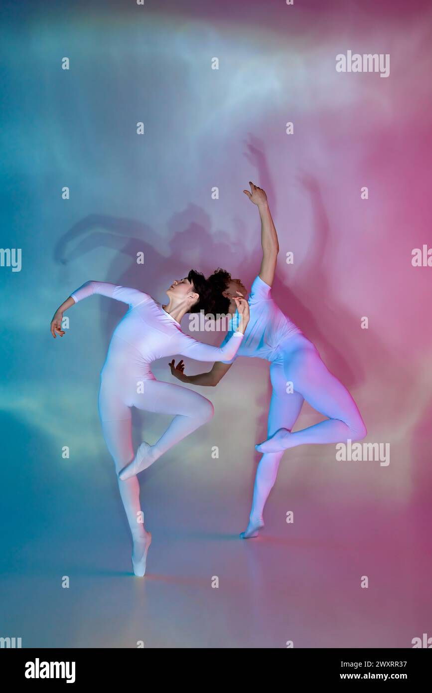 Dynamic portrait of two ballet dancers in white leotards expressing ...