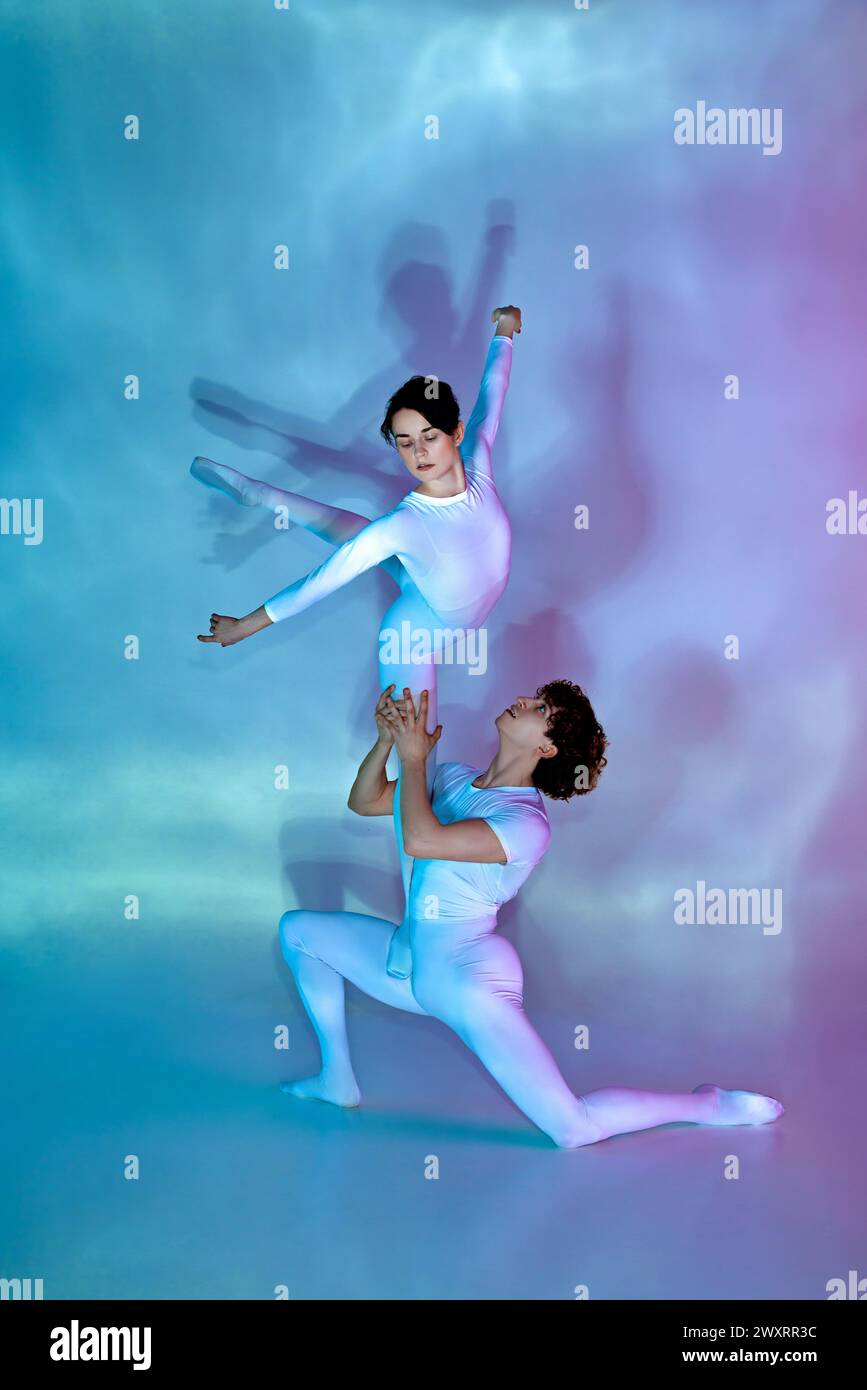 Contemporary ballet duo mid-performance, male dancer lifting female ...