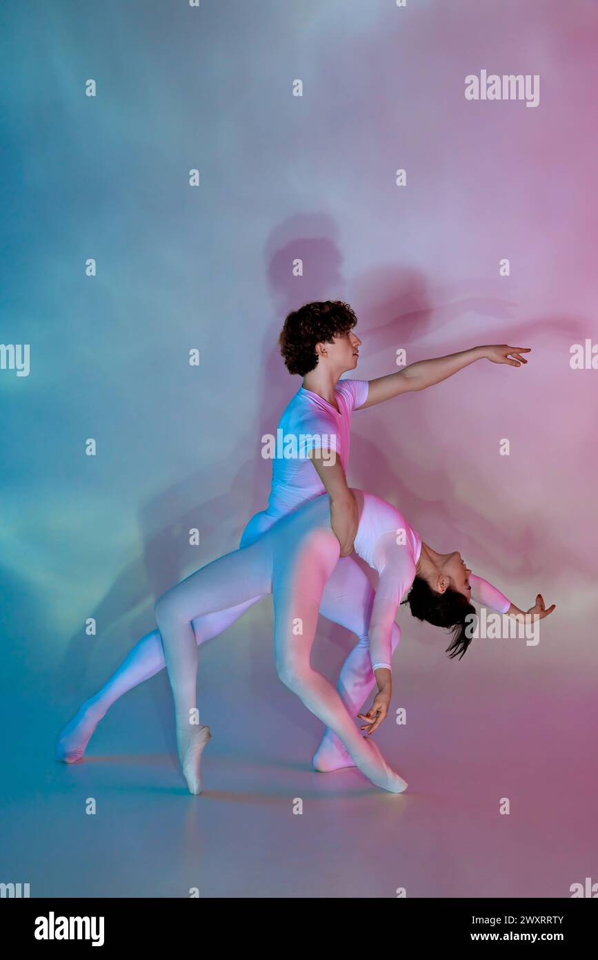 Dramatic ballet lift, male supporting a poised female dancer, both in ...