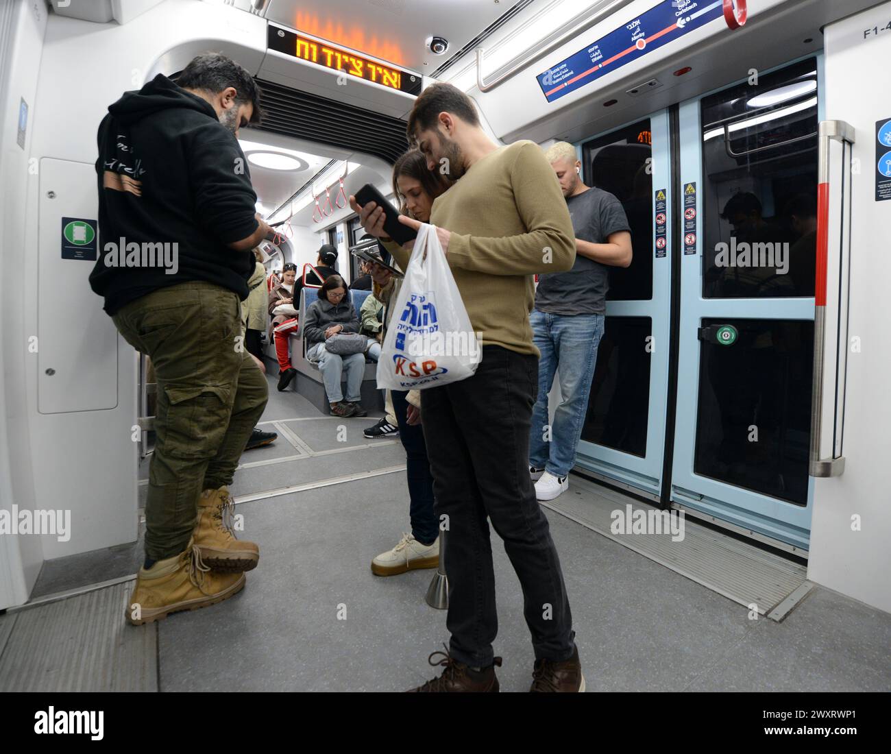 Passengers riding on the modern light railway train in Tel-Aviv, Israel ...