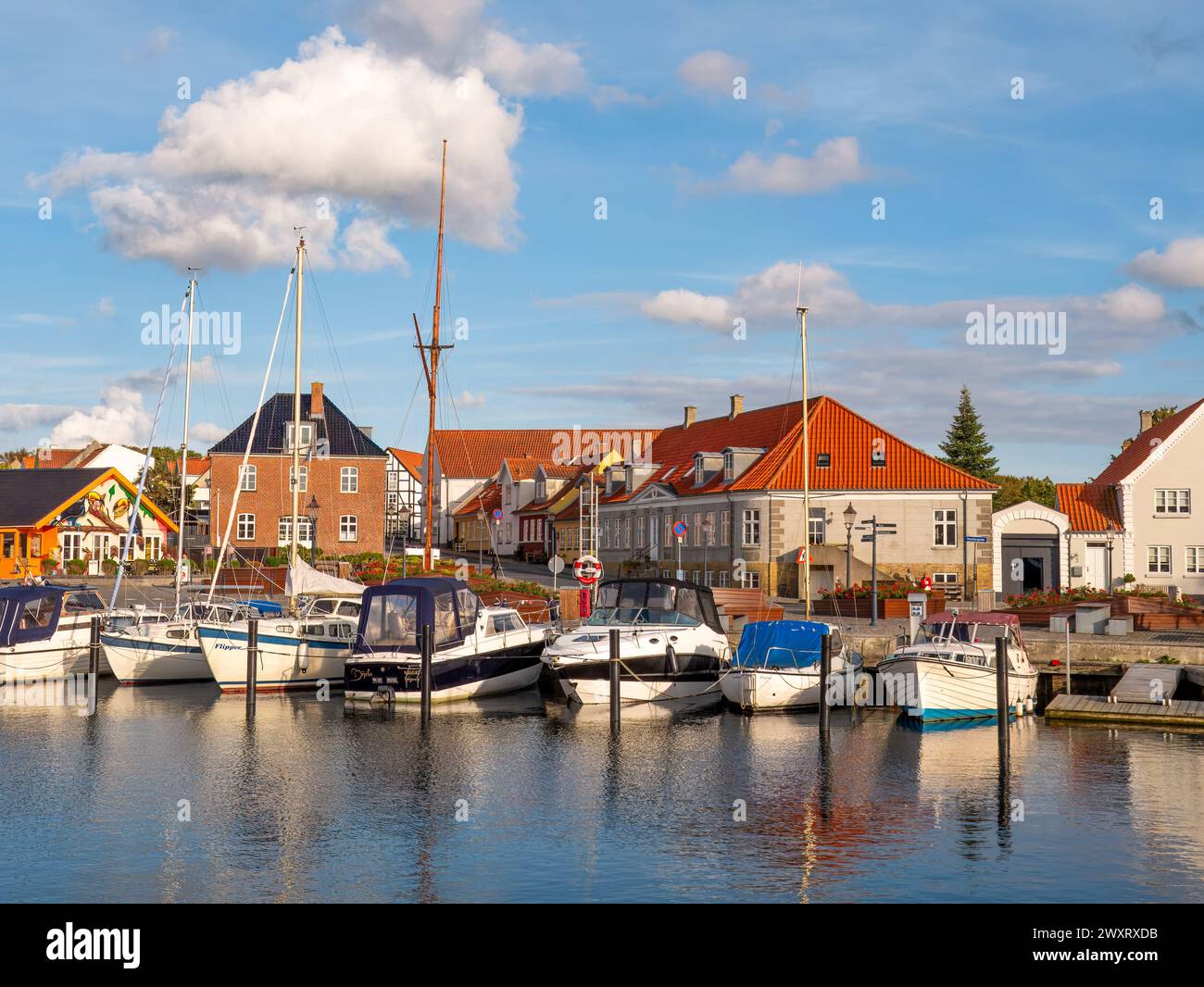 Boats in harbour and scenic houses in Adelgade street in old town of ...