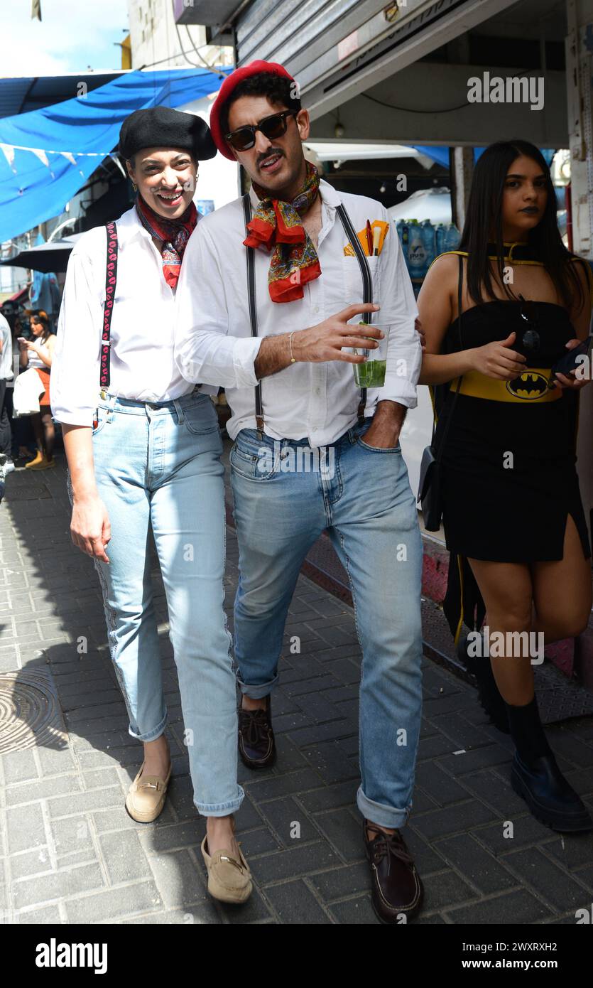 Israelis wearing costumes at the Carmel market during Purim festival ...