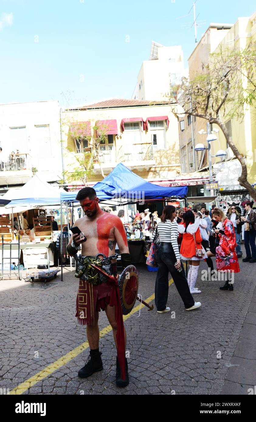 Israelis wearing costumes at the Carmel market during Purim festival ...