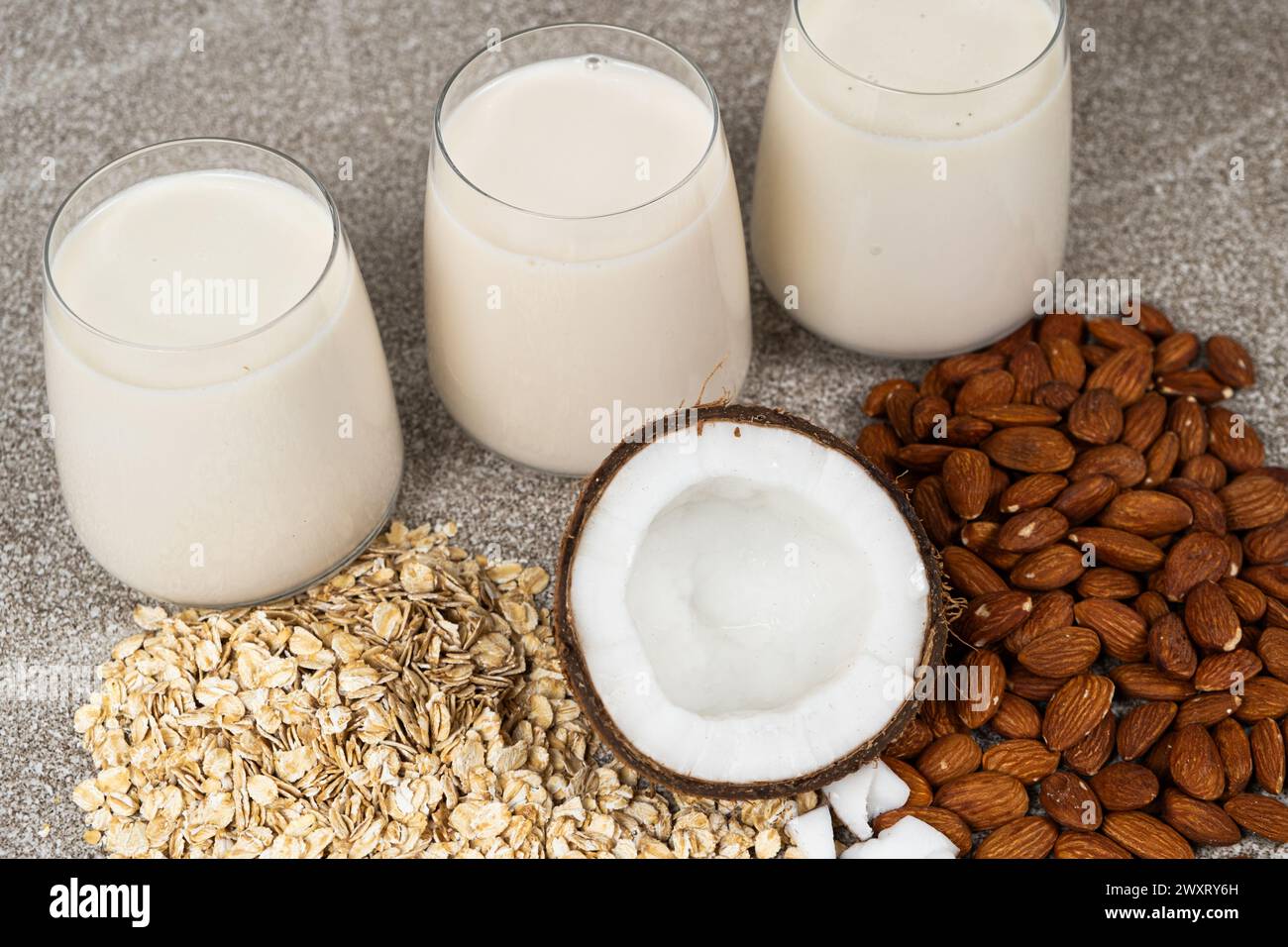 Types of plant-based milk in glasses. Oat, coconut and almond milk ...