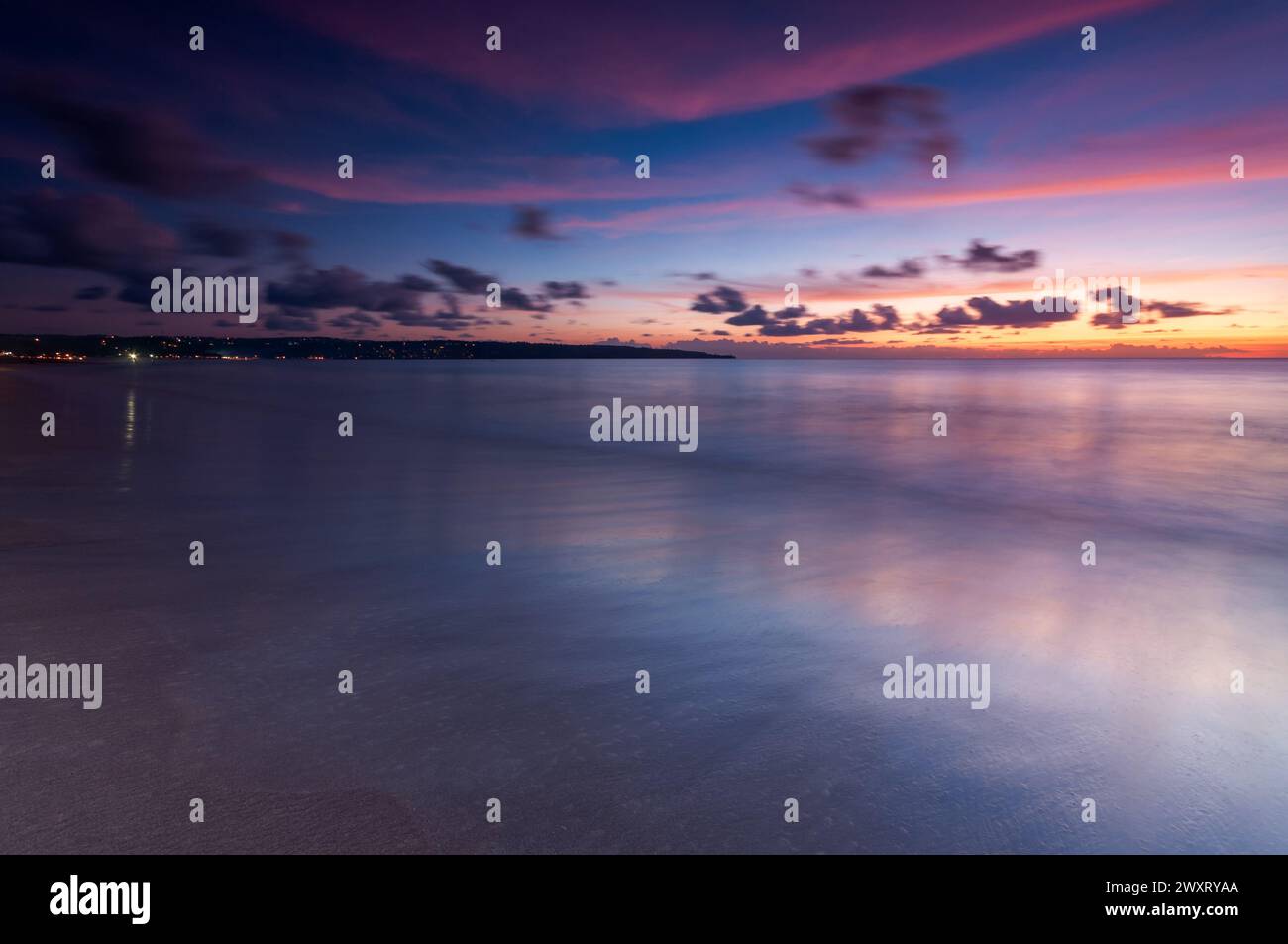 Sunset at Jimbaran beach in Bali Indonesia Stock Photo - Alamy
