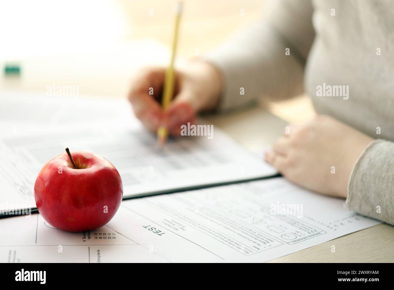 Female student hands testing in exercise and taking fill in exam paper ...