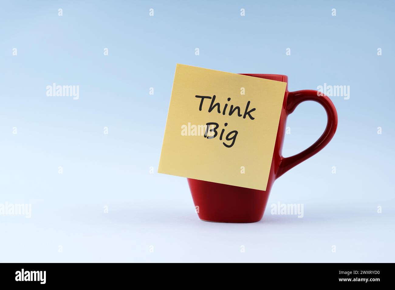 Think big text on adhesive note stick on a coffee cup Stock Photo - Alamy