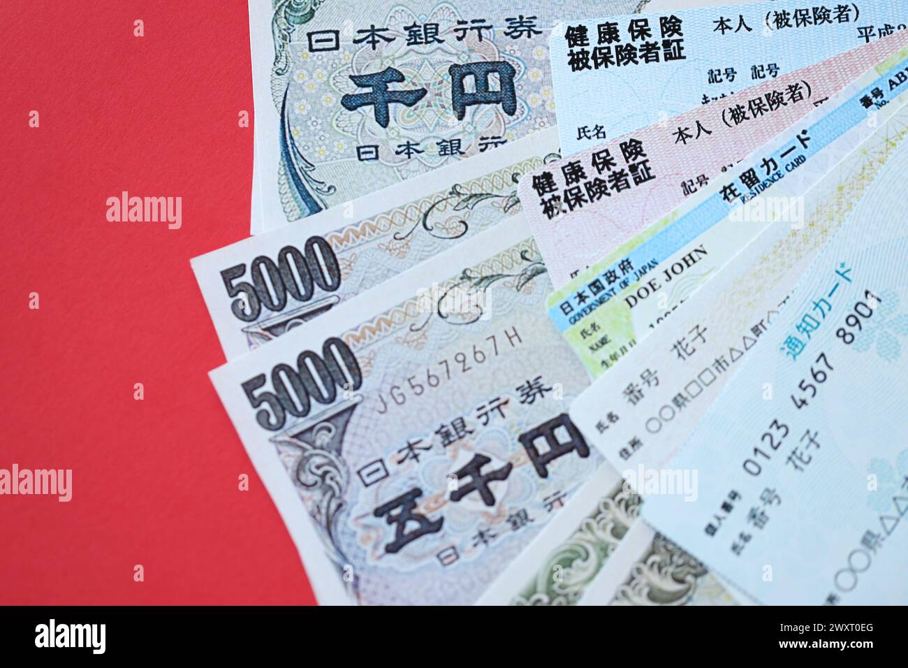Light blue and red Japan Health Insurance cards on table with japanese ...