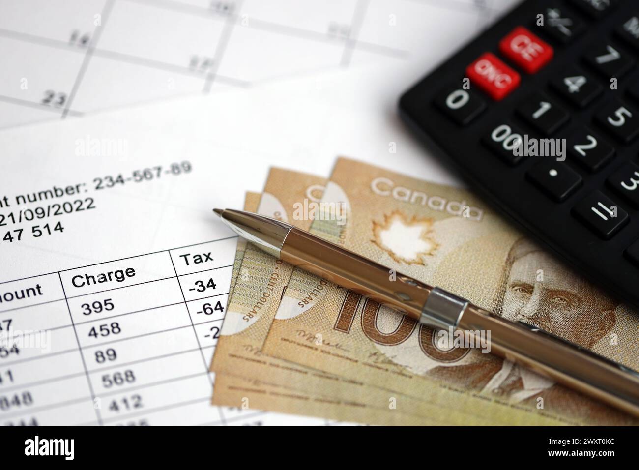 Many calculation results in schedules lies on table with canadian money ...