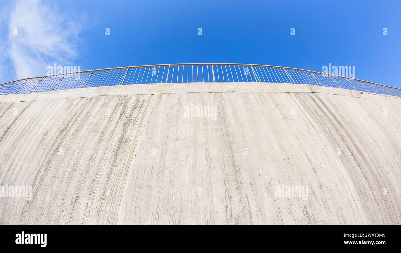 High concrete wall structure with steel fence railing for public safety ...