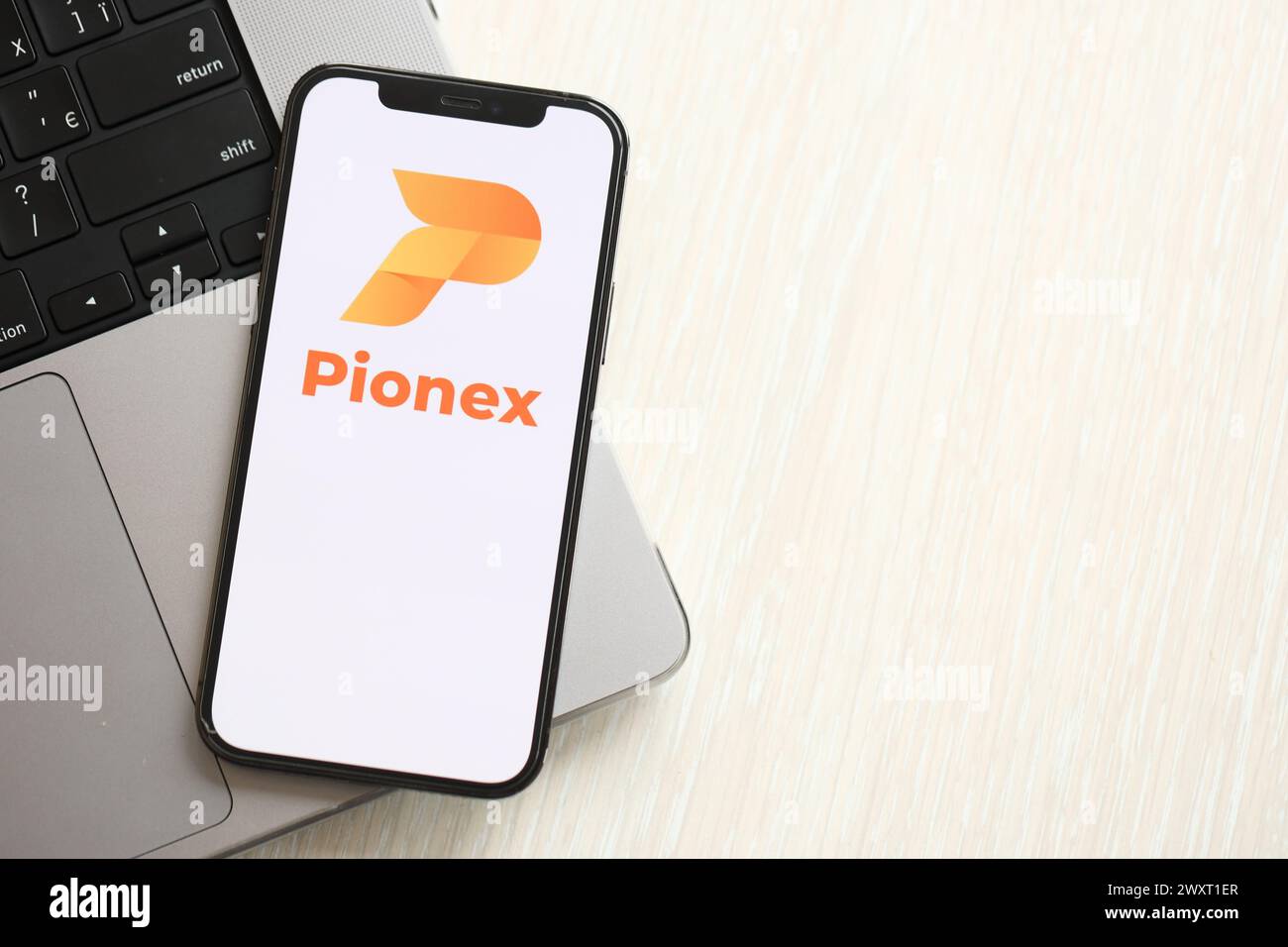 KYIV, UKRAINE - MARCH 15, 2024 Pionex logo on iPhone display screen on ...