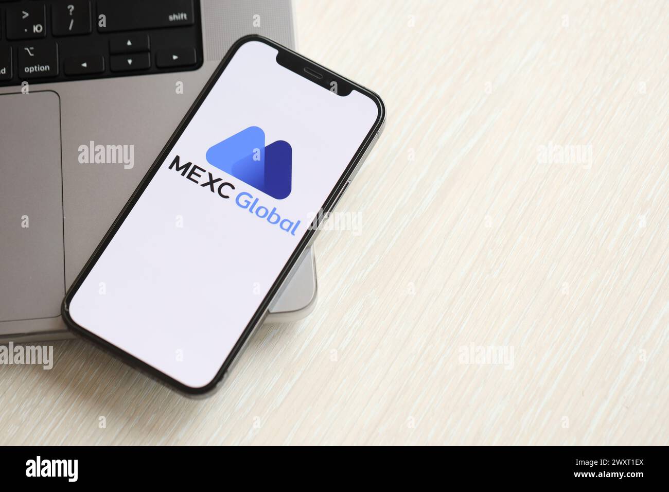 KYIV, UKRAINE - MARCH 15, 2024 MEXC logo on iPhone display screen on ...